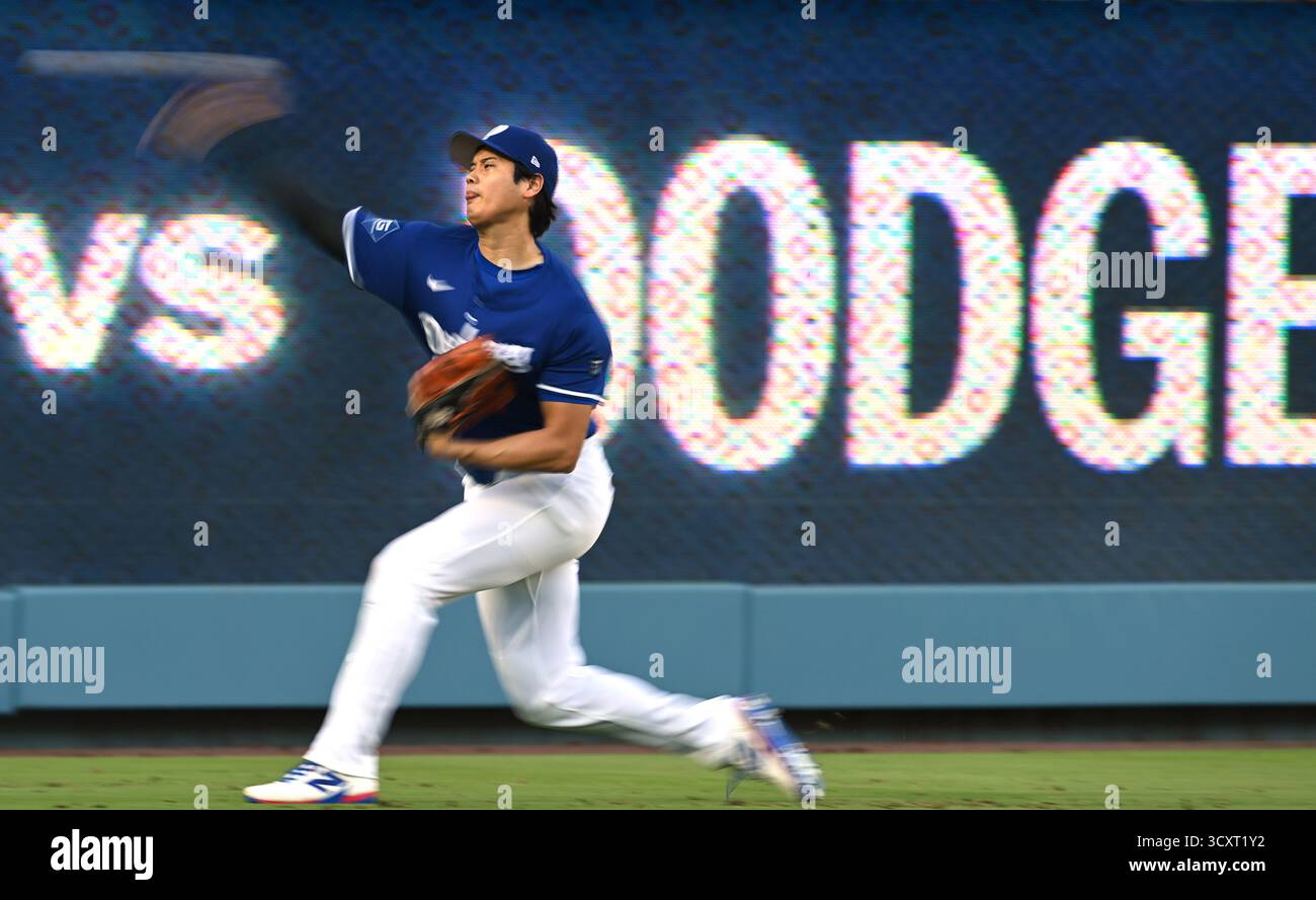 Los Angeles Dodgers two-way player Shohei Ohtani plays catch during a ...