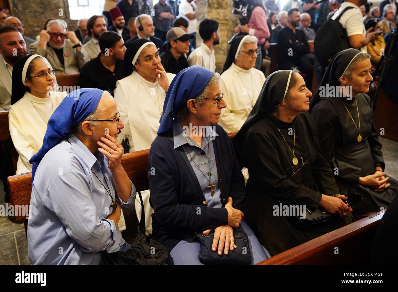 Nuns attend the reopening ceremony of St. Thomas Syriac Orthodox Church ...