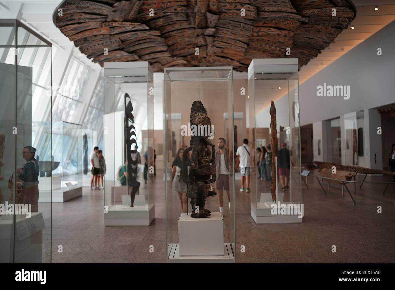 Visitors viewed a wood carving from New Ireland, Papua New Guinea, on ...