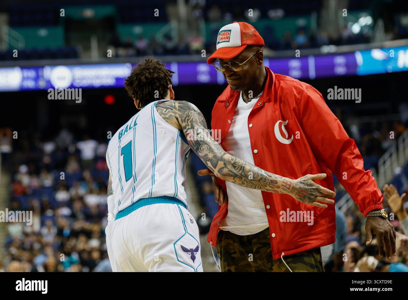 Charlotte Hornets guard LaMelo Ball bumps a fan on the court during the ...