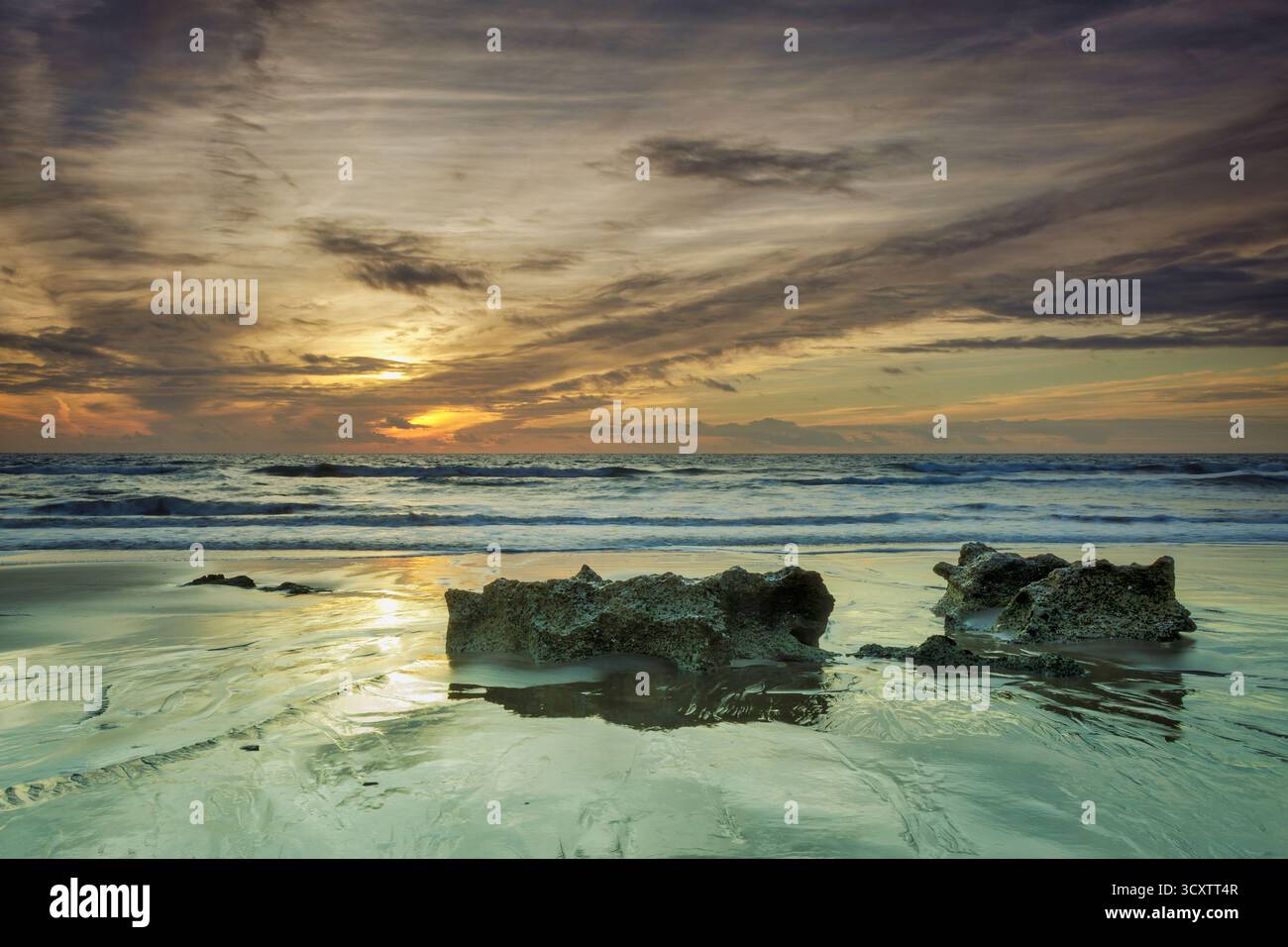 Symmetrical view of the sunset at Playa del Puerco, showing the ...