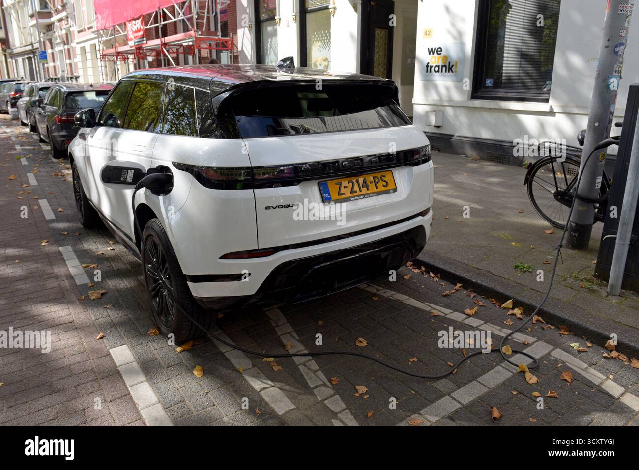 An electric Range Rover Evoque car on charge on the street in Rotterdam ...