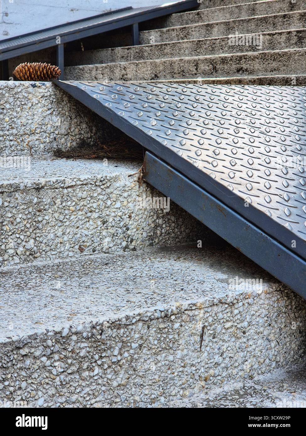 Concrete stairs with ramp in the park. Pine cone on the stairs. Modern ...