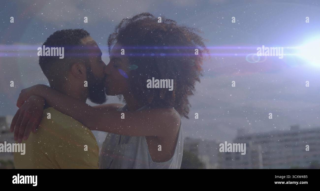 Kissing couple embracing on rooftop terrace wearing yellow T-shirt with ...