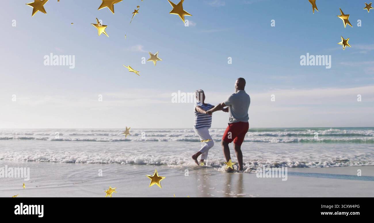 Dancing couple holding hands stepping in shallow ocean waves at sandy ...
