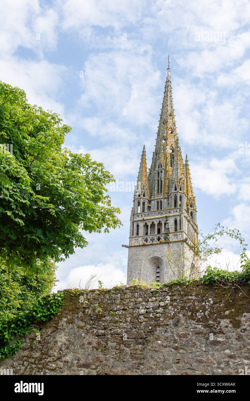 The tall Gothic church spire of Pont-Croix in Brittany, a region of ...