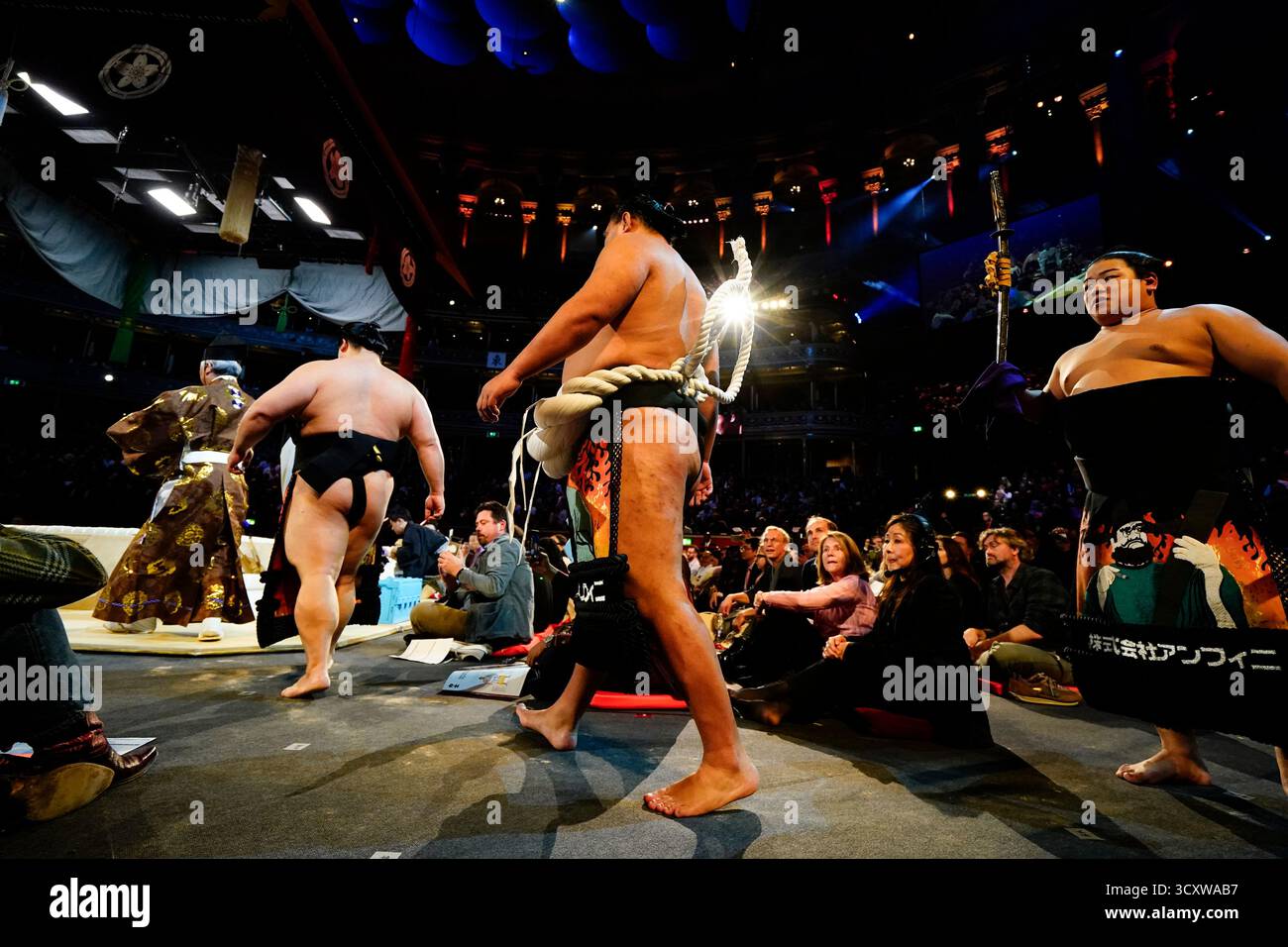 Spectators look on as the rikishi walk out during the opening ceremony ...
