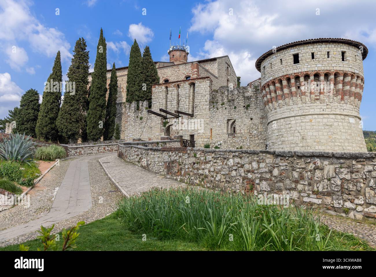 Historic Brescia Castle rising above stone pathway with massive ...