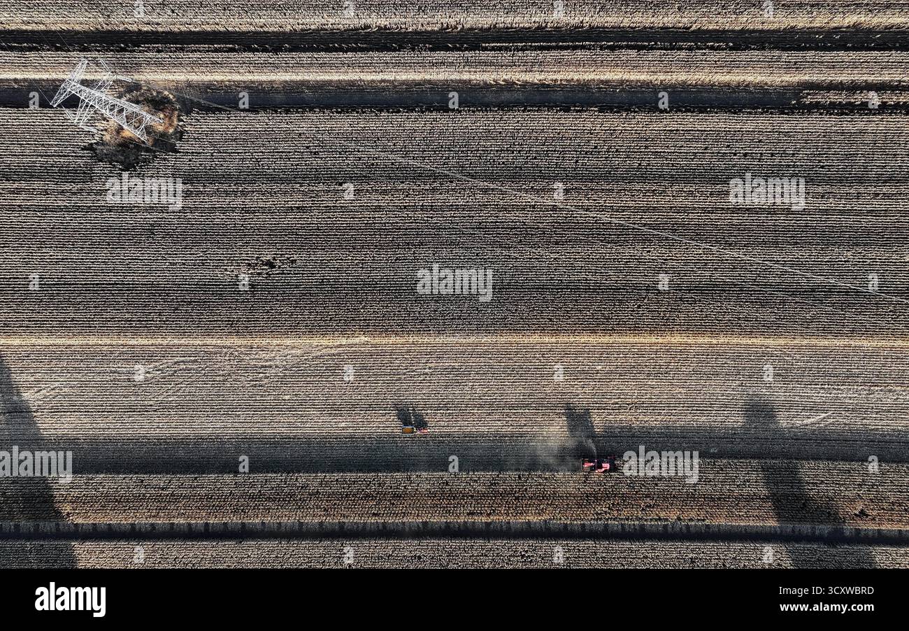 Aerial photo shows harvesters working in the field in Harbin City ...