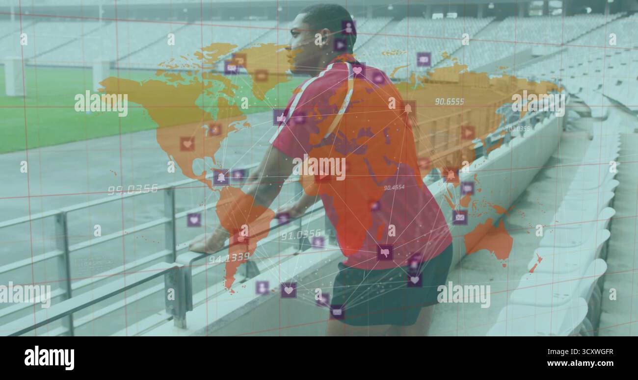 Leaning male athlete gazing at turf from metal railing at sports ...