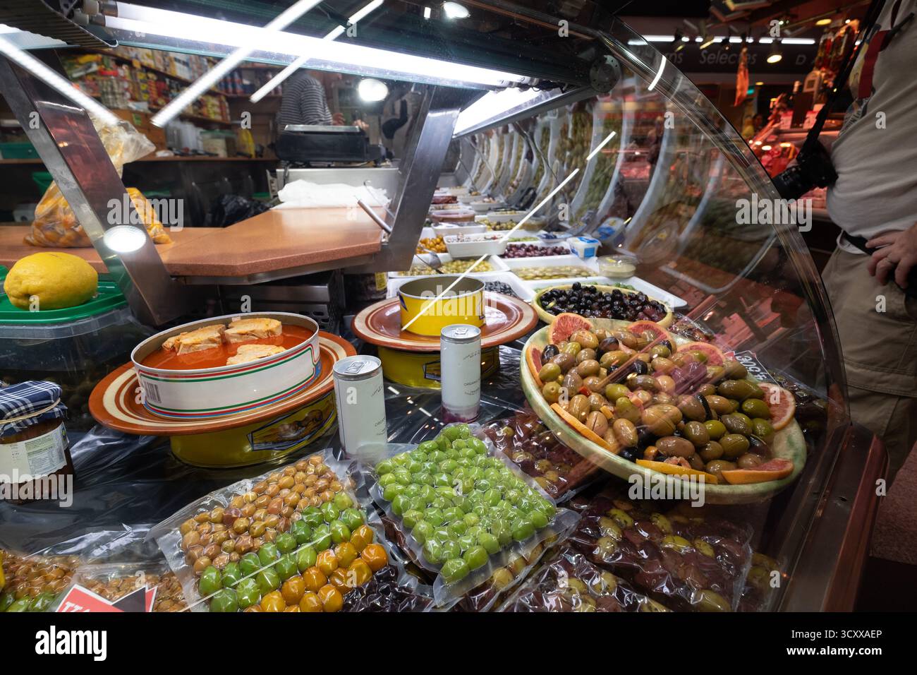 Deli counter with assorted Mediterranean olives, cheeses, preserves ...