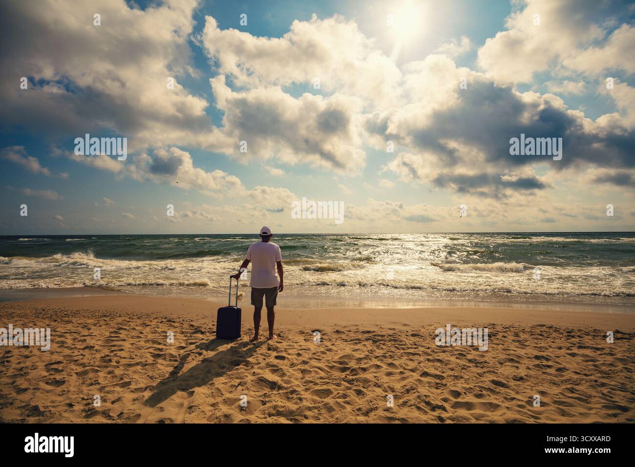 Yellow suitcase stands on beach hi-res stock photography and images - Alamy