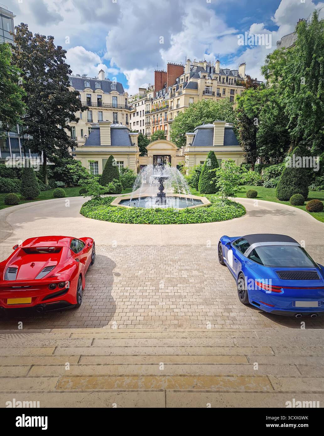 Two luxury sports cars parked in the driveway of an opulent Parisian ...