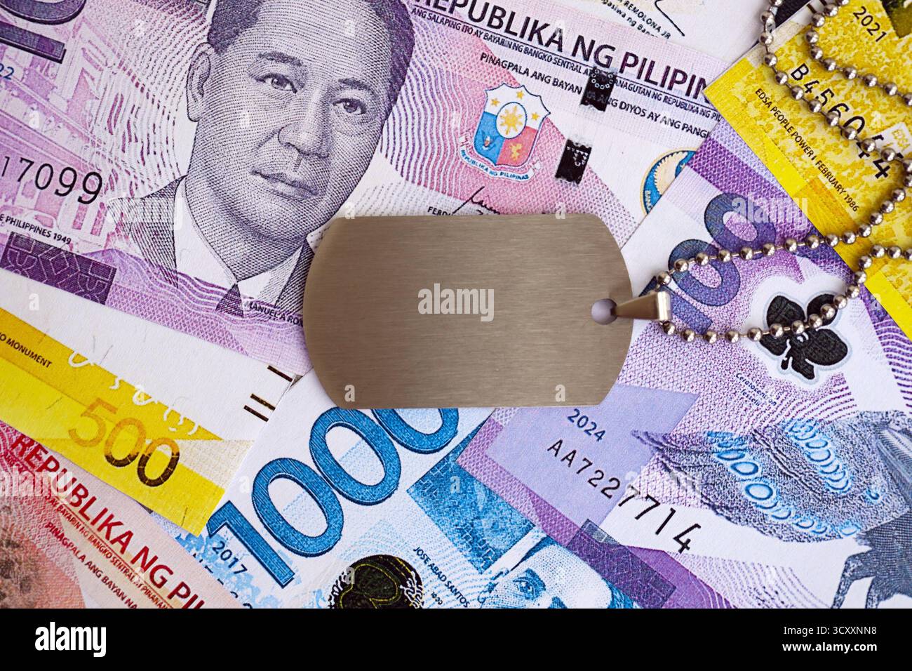 Philippines peso currency money bills and military token close up. The ...