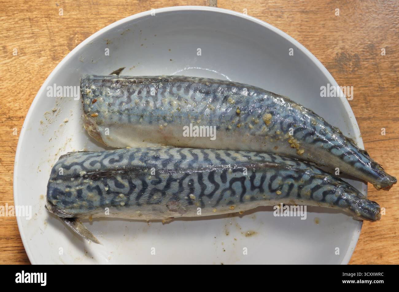 Two raw mackerel fish in a bowl Stock Photo - Alamy