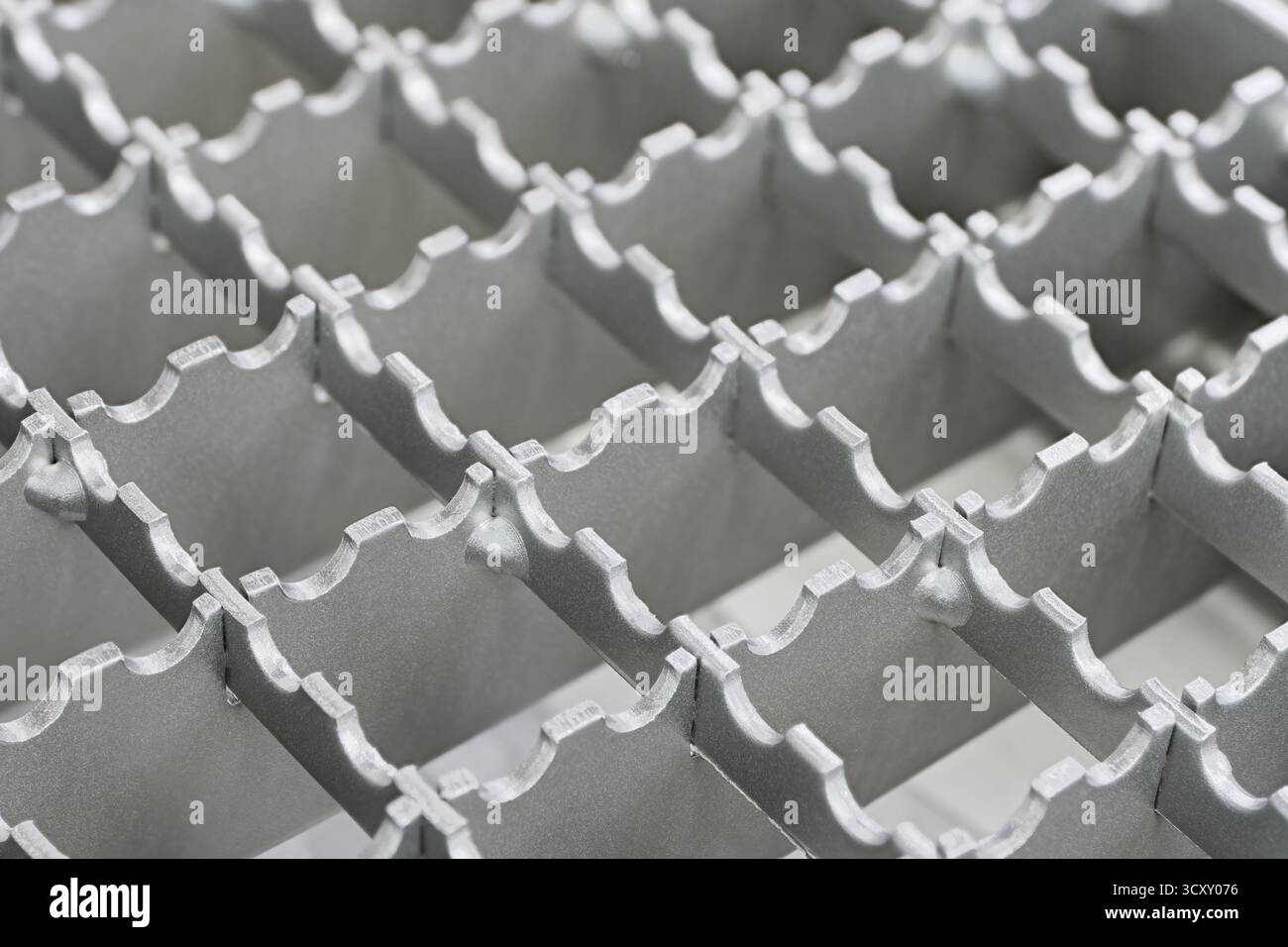 Openwork serrated metal lattice with square cells, close-up shot ...