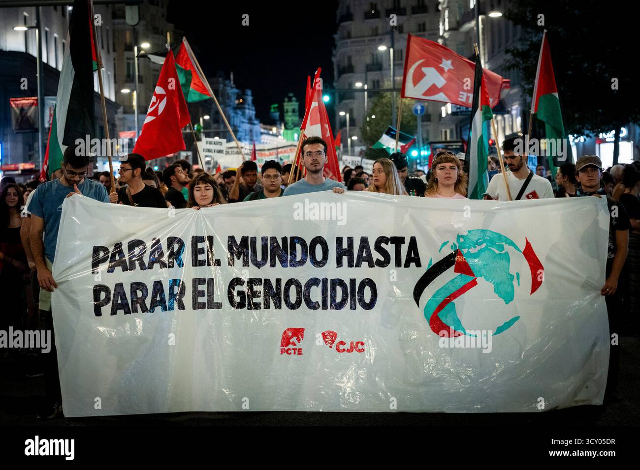 Some protesters hold a huge banner with the slogan 'Stop the world ...