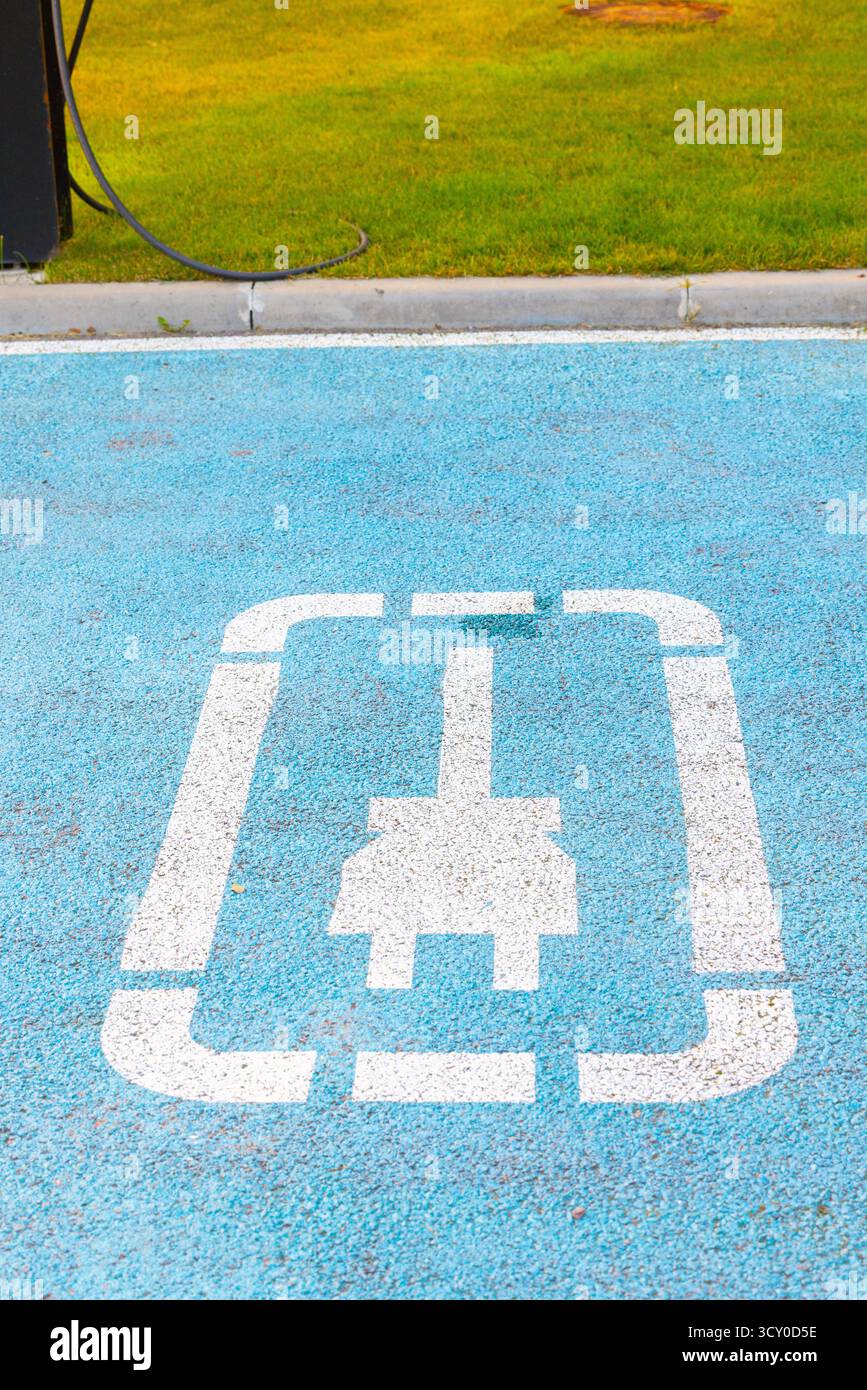 Electric charging sign painted on parking spot for electric vehicles ...