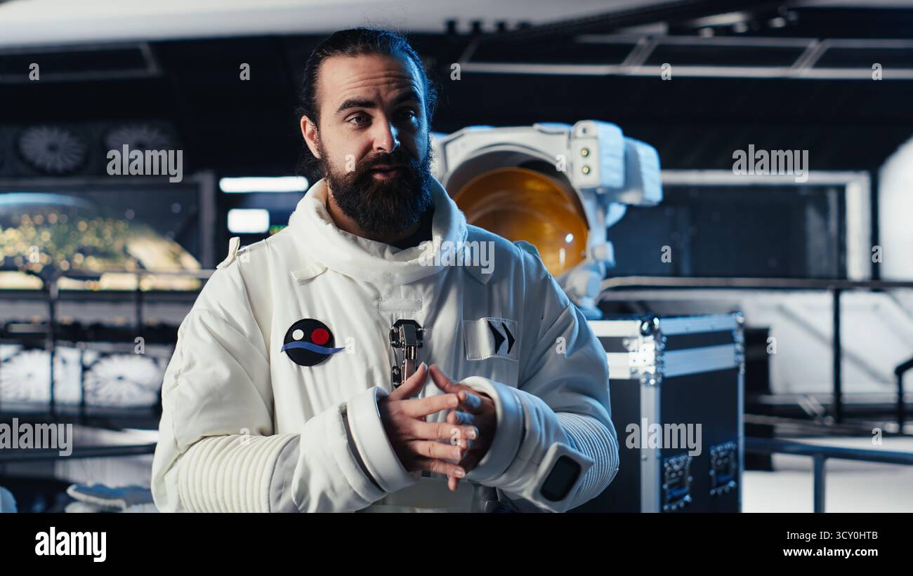 Astronaut waves hand, communicating with command center during ...
