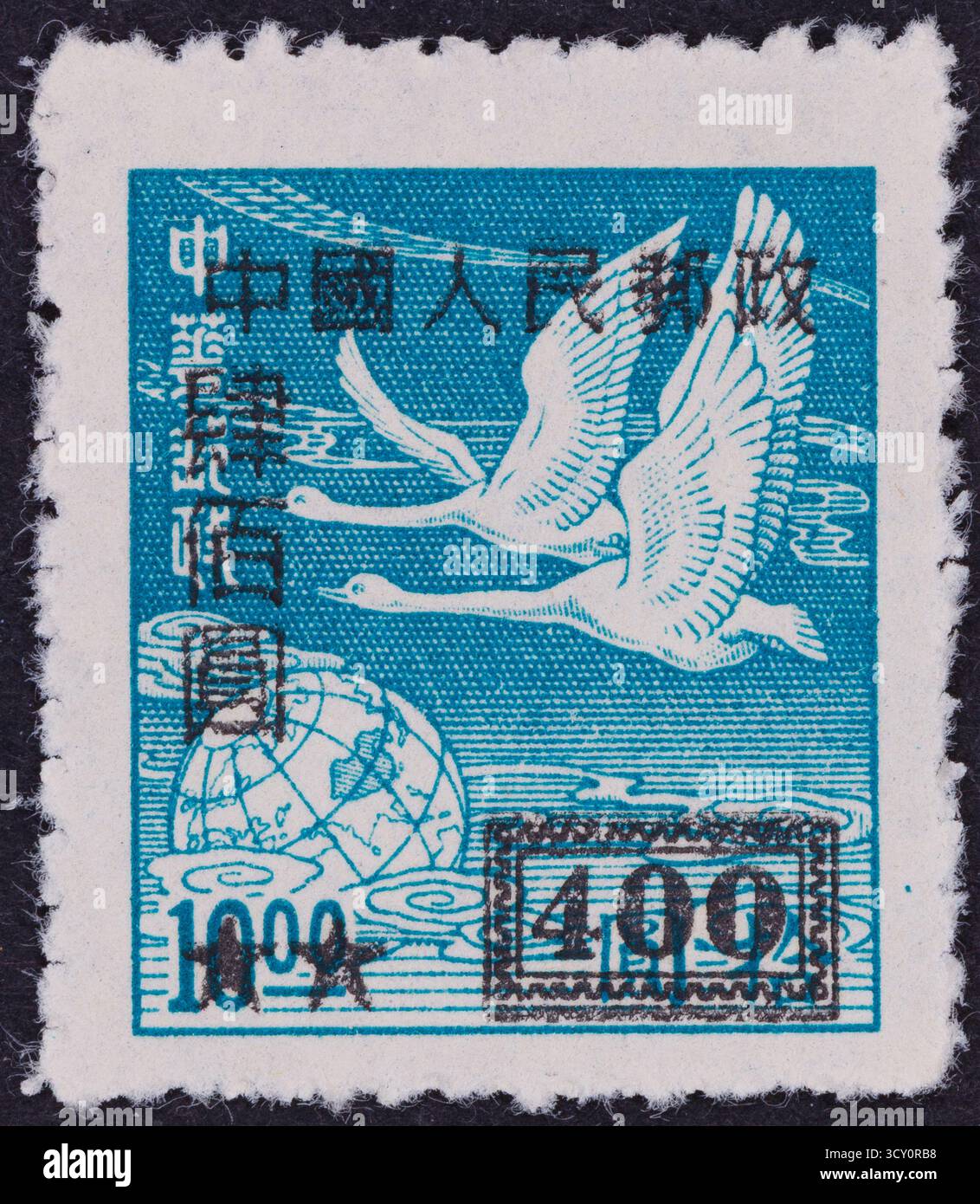 A blue postage stamp depicts two white flying swans above a globe and ...