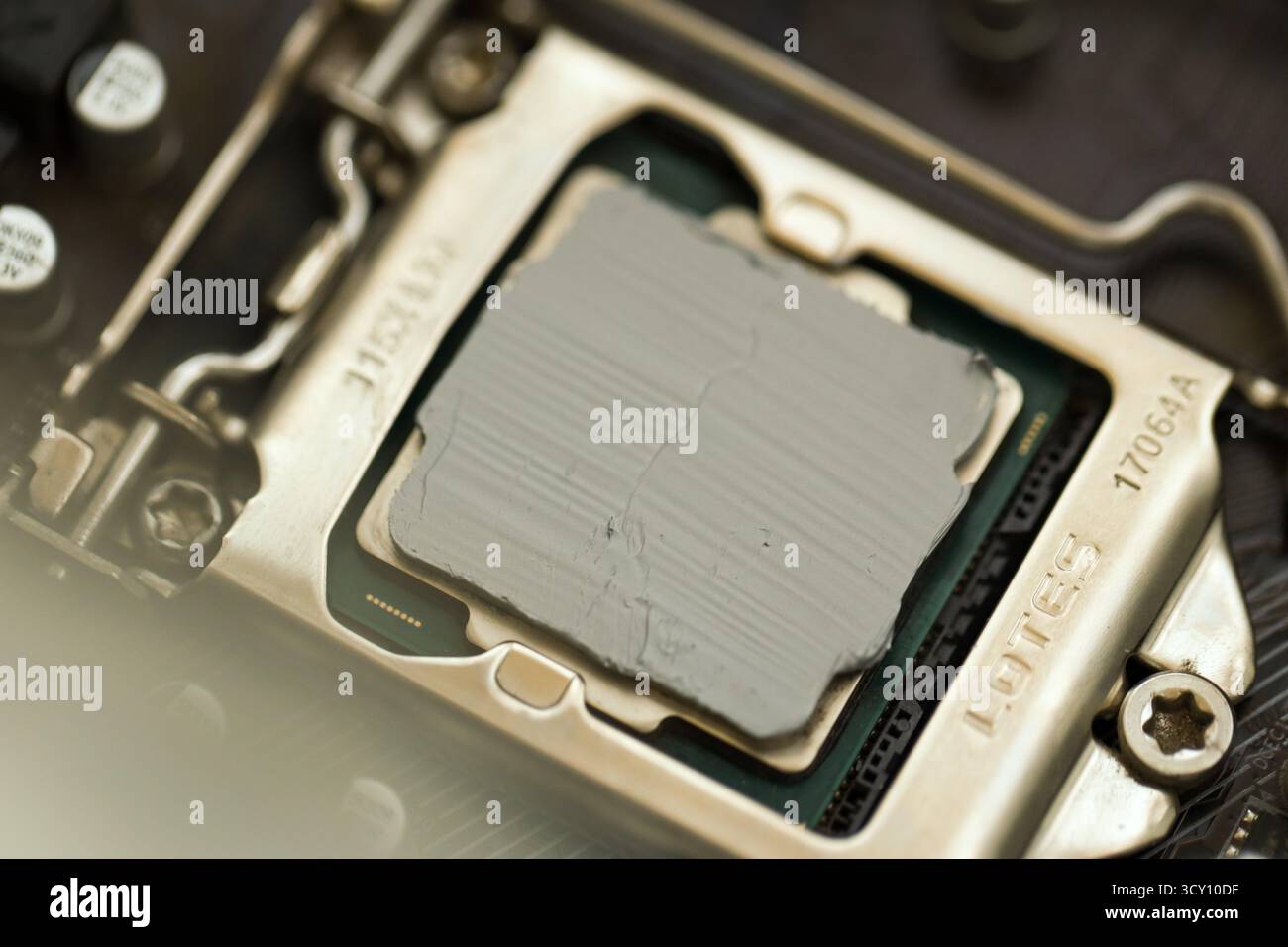 KYIV, UKRAINE - JANUARY 29, 2025 applying thermal paste on a processor ...
