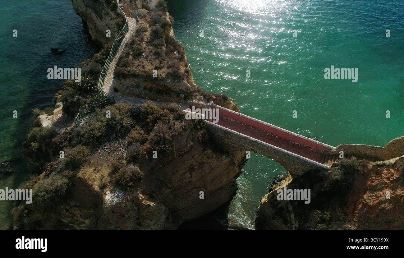 Aerial perspectives of the golden cliffs holding iconic Roman Bridge on ...
