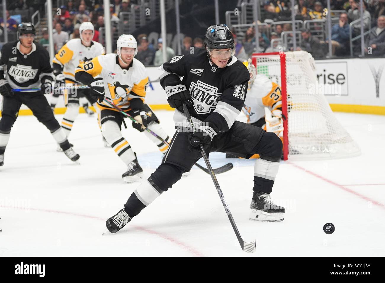 Los Angeles Kings center Alex Turcotte (15) moves the puck during the ...