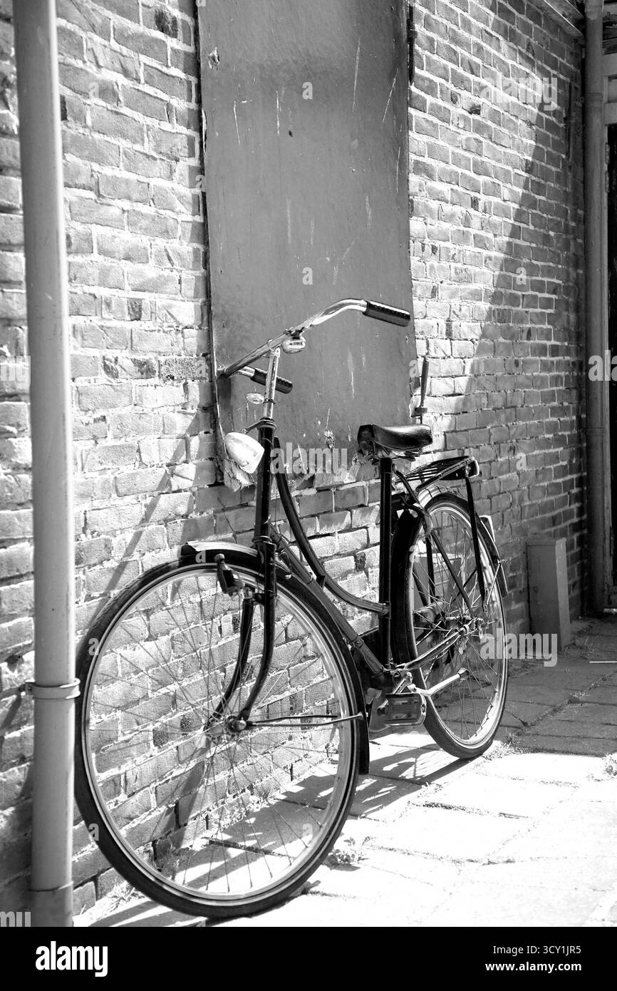 Parked bicycle wheel Black and White Stock Photos & Images - Alamy
