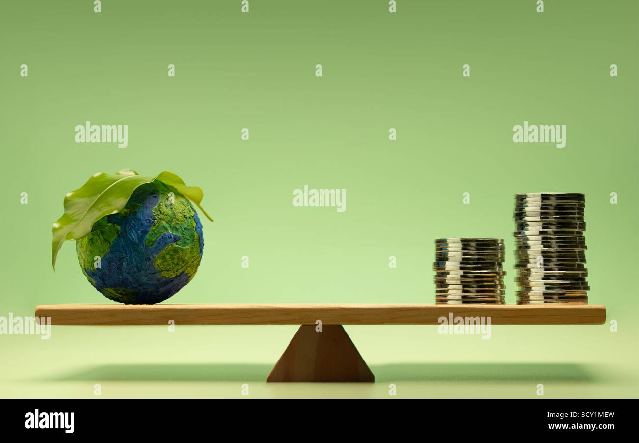 Sustainable Economy Balance with Earth and Money Stock Photo - Alamy