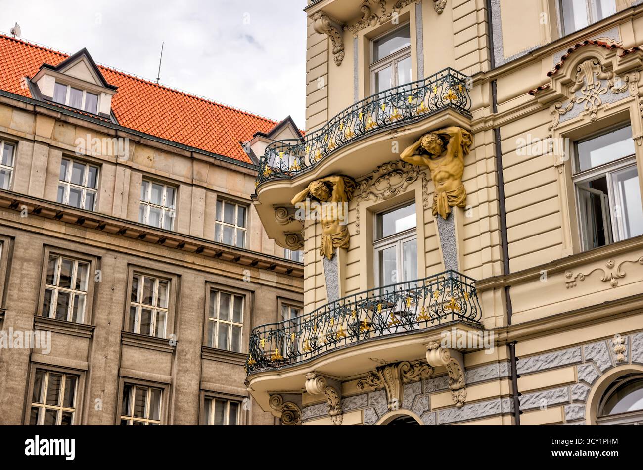 Balcony supported by golden sculpted figures on an ornate historic ...