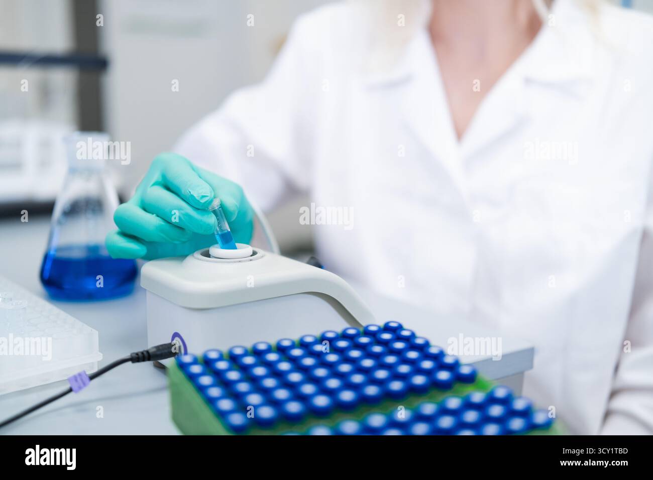 Analytical chemist preparing samples for HPLC analysis to identify and ...