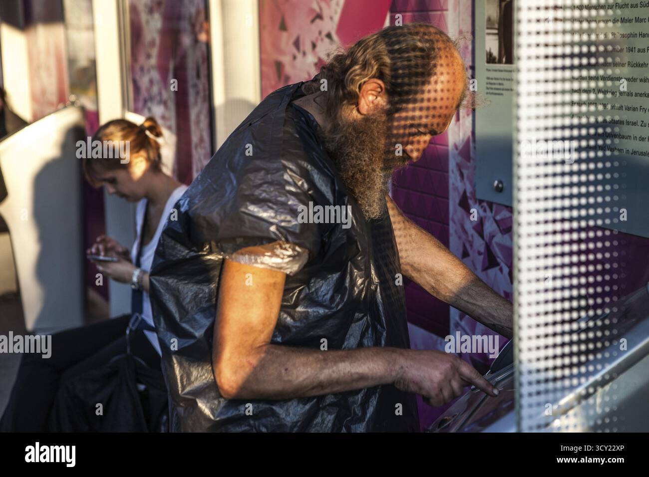DEU Germany Germany Berlin Homeless person with plastic bag and feet ...