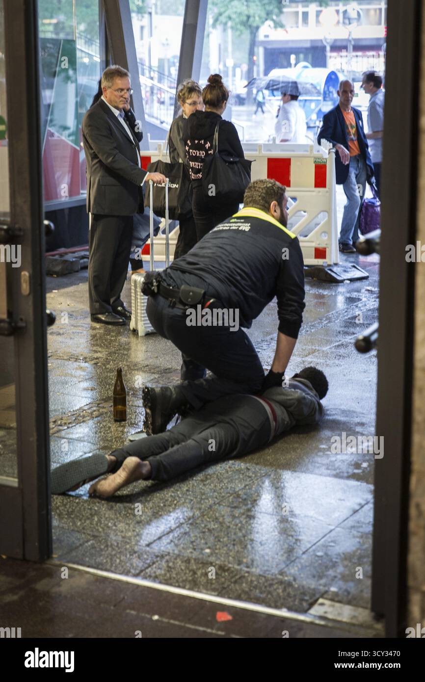 DEU Germany Germany Berlin BVG security staff hold a man on the ground ...