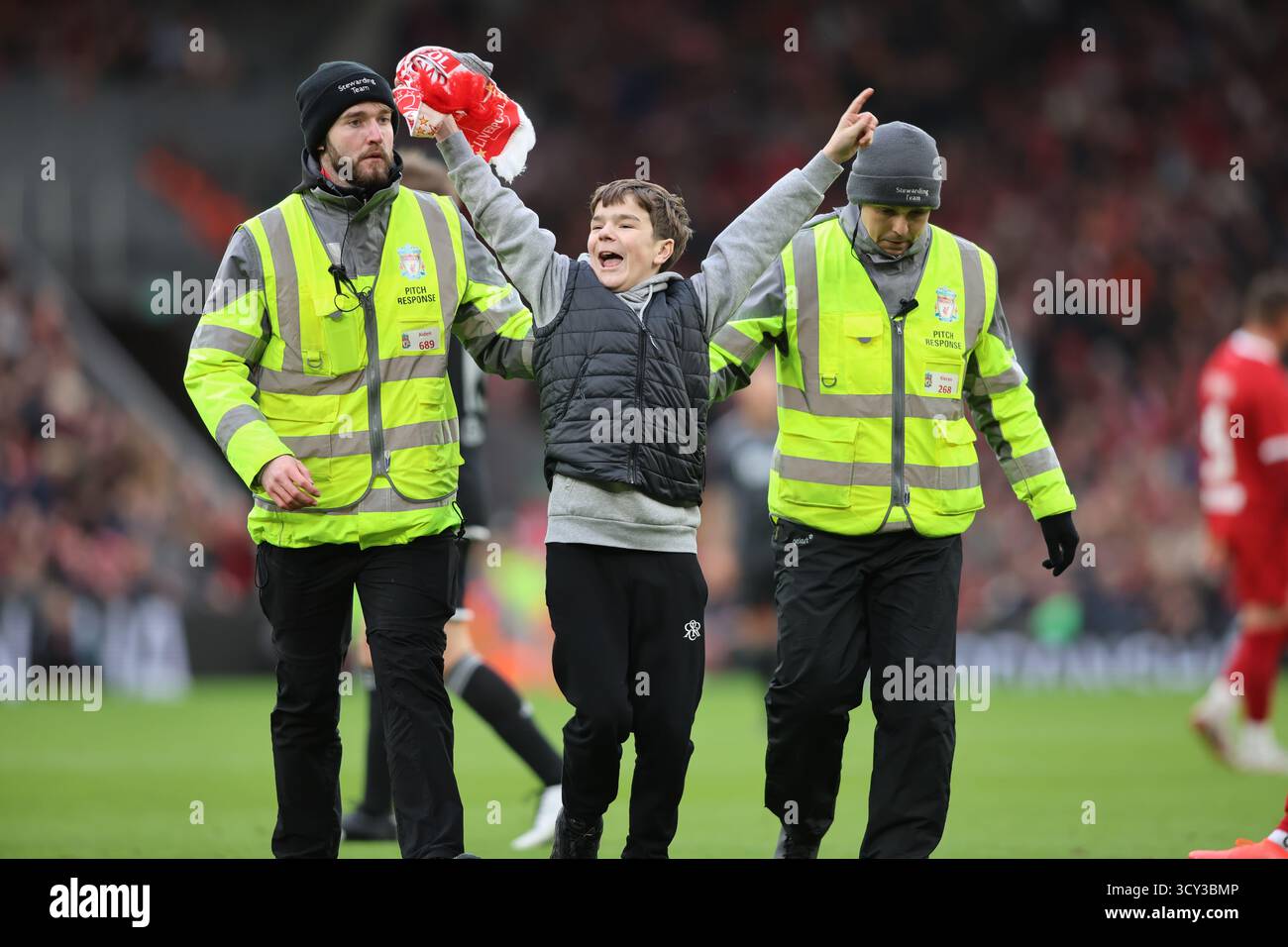 Pitch invader with stewards of Liverpool FC during the matchLiverpool ...