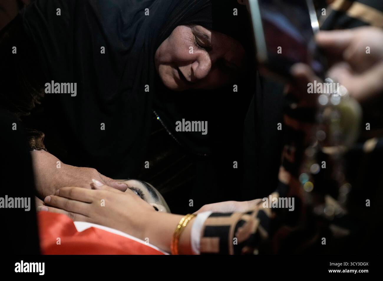 A Palestinian woman woman mourns over the the body of Mahdi Kamil, 20 ...