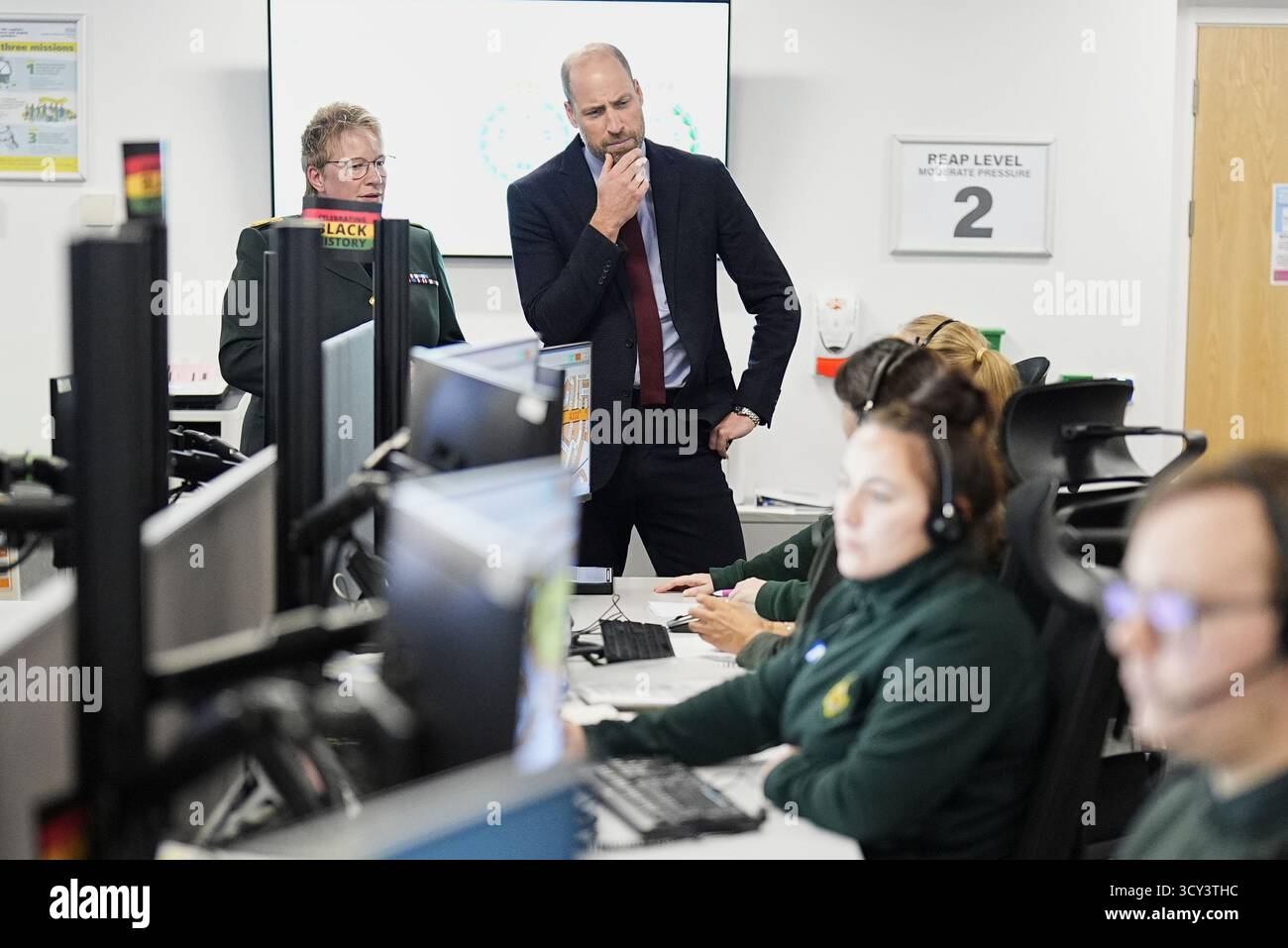Britain's Prince William, flanked by Chief Paramedic Pauline Cranmer ...