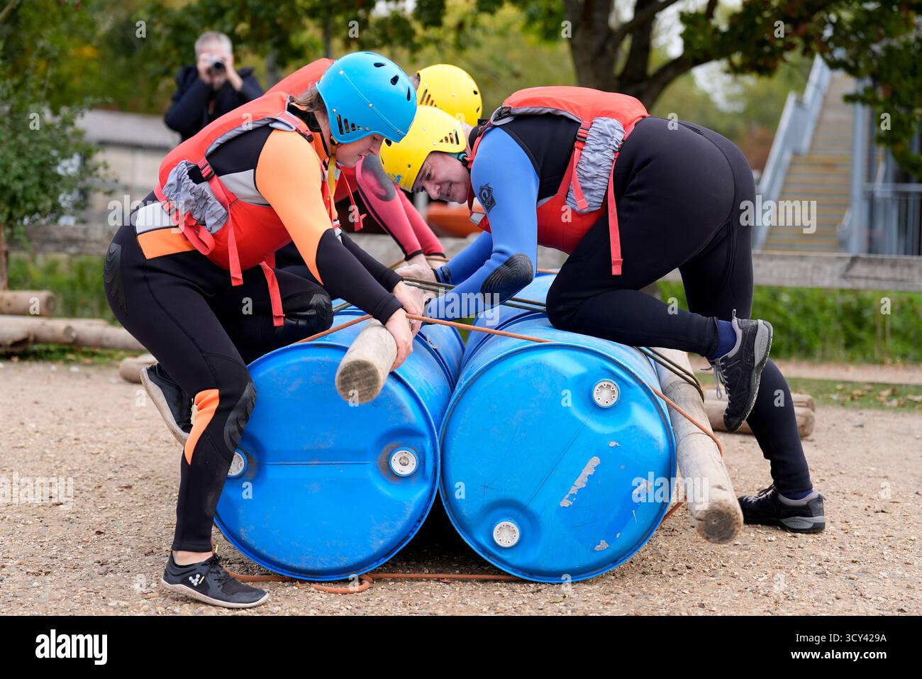 Liberal Democrat Party leader Sir Ed Davey (right ]) helps build a raft ...