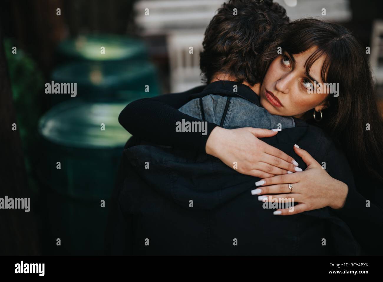 Woman embraces man while expressing deep emotion and intense ...