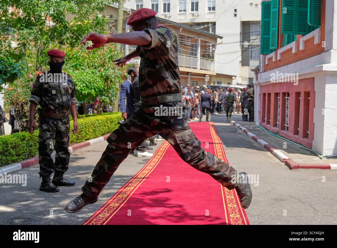 A Madagascar soldier jumps over the red carpet prior to the arrival of ...