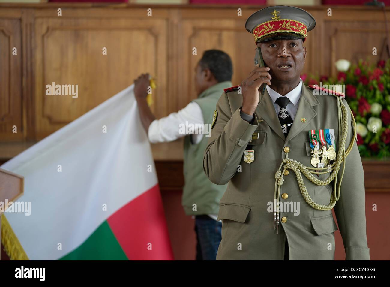 A Madagascar military officer makes a phone call before the swearing-in ...