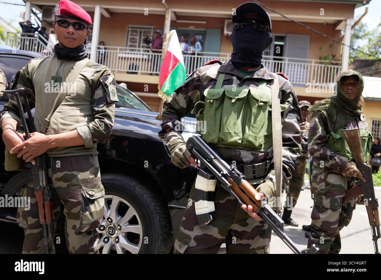 Soldiers guard Col. Michael Randrianirina's car after his swearing-in ...