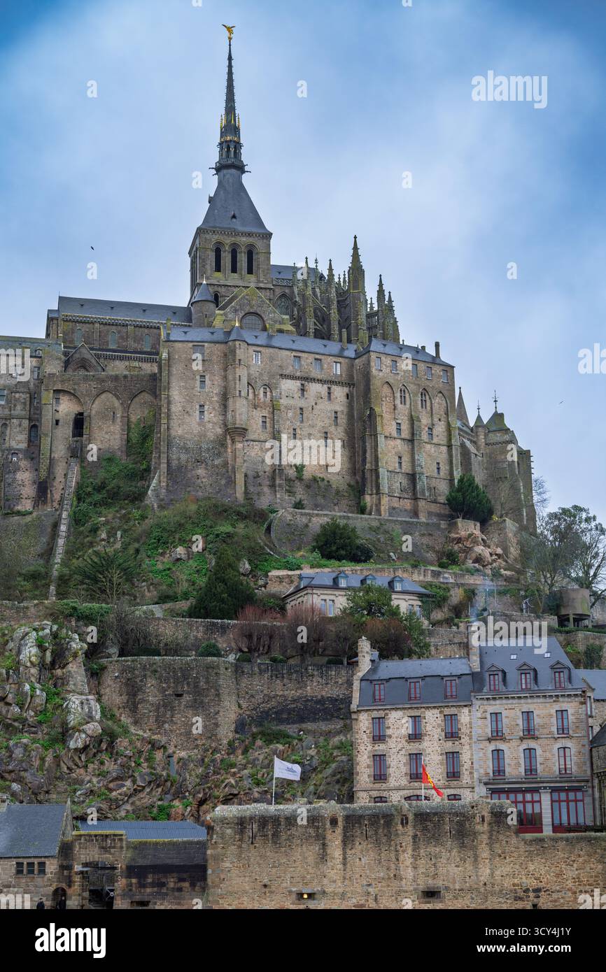 The majestic Mont Saint Michel abbey and fortified village rise from ...
