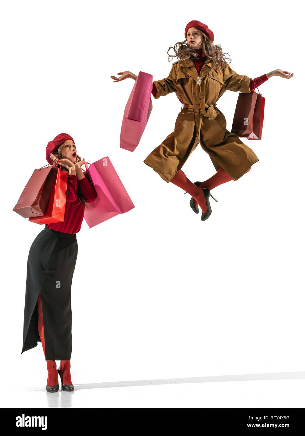Stylish woman jumping with shopping bags expressing elegance and retail ...