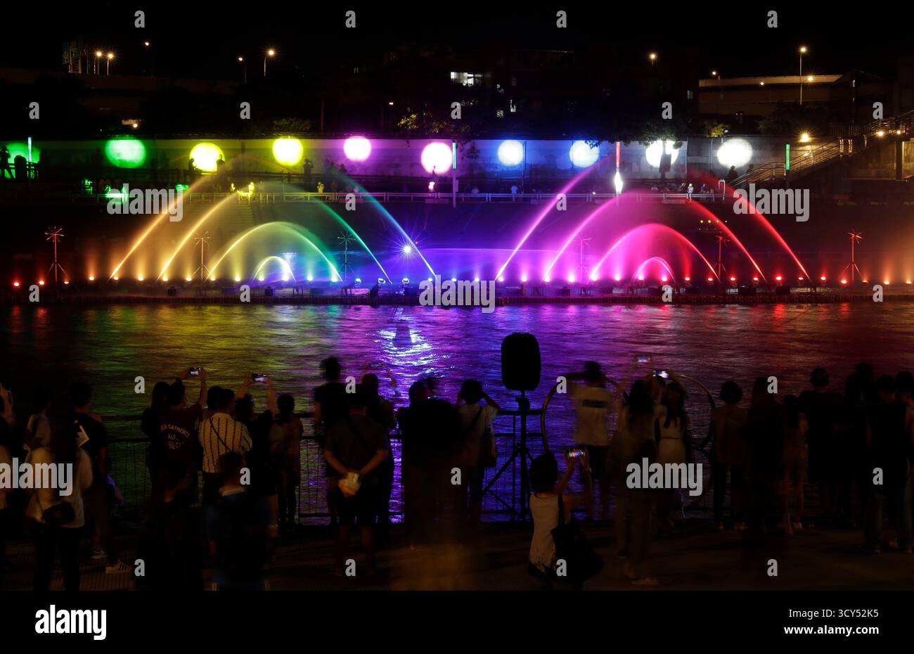 People visit the water dance show in Taipei, Taiwan, Friday, Oct. 17 ...