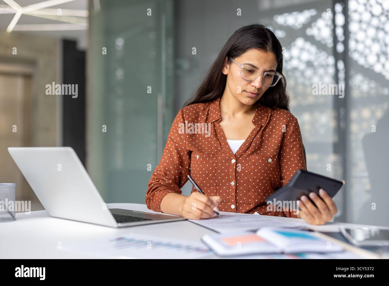 Reviewing charts woman taking notes hi-res stock photography and images ...