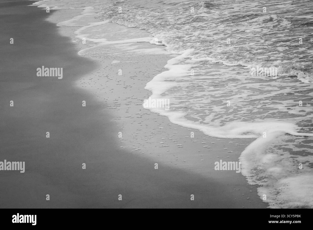 Calm water waves washing shore Black and White Stock Photos & Images ...