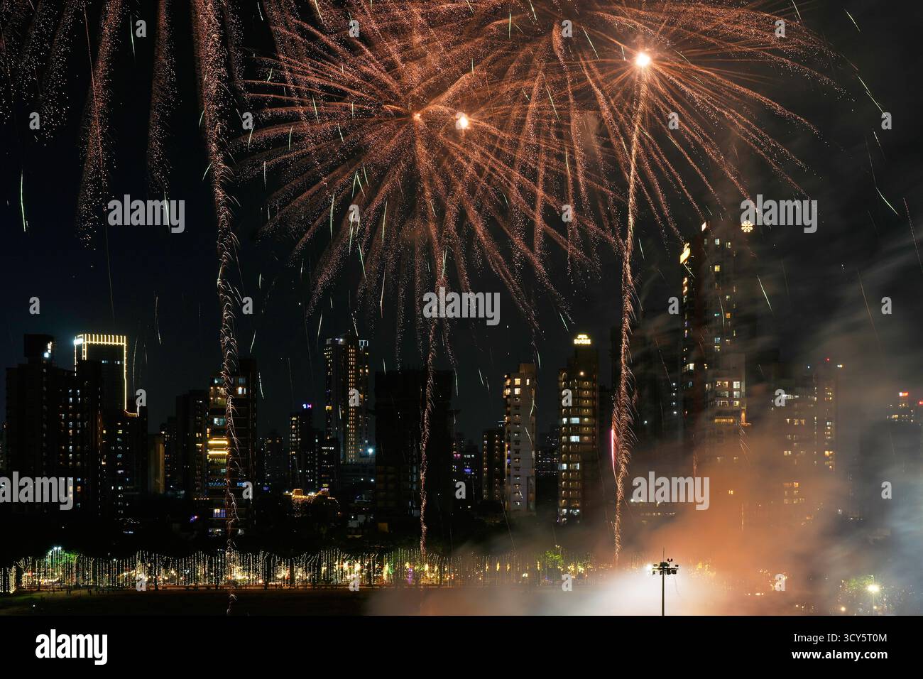 Fire crackers and smoke fill the city skyline as a part of Diwali ...
