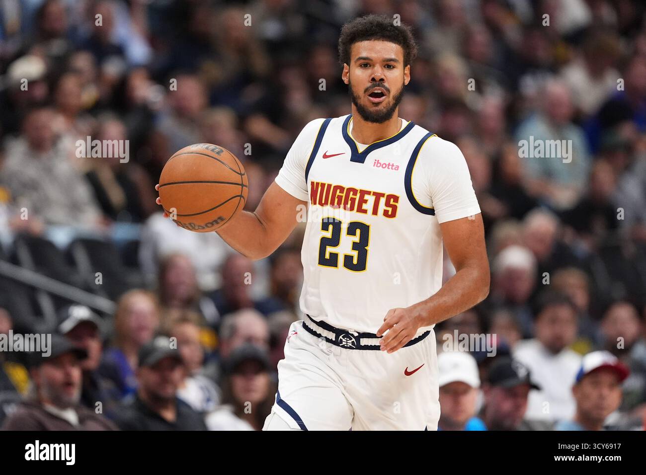 Denver Nuggets forward Cameron Johnson brings the ball up court against ...
