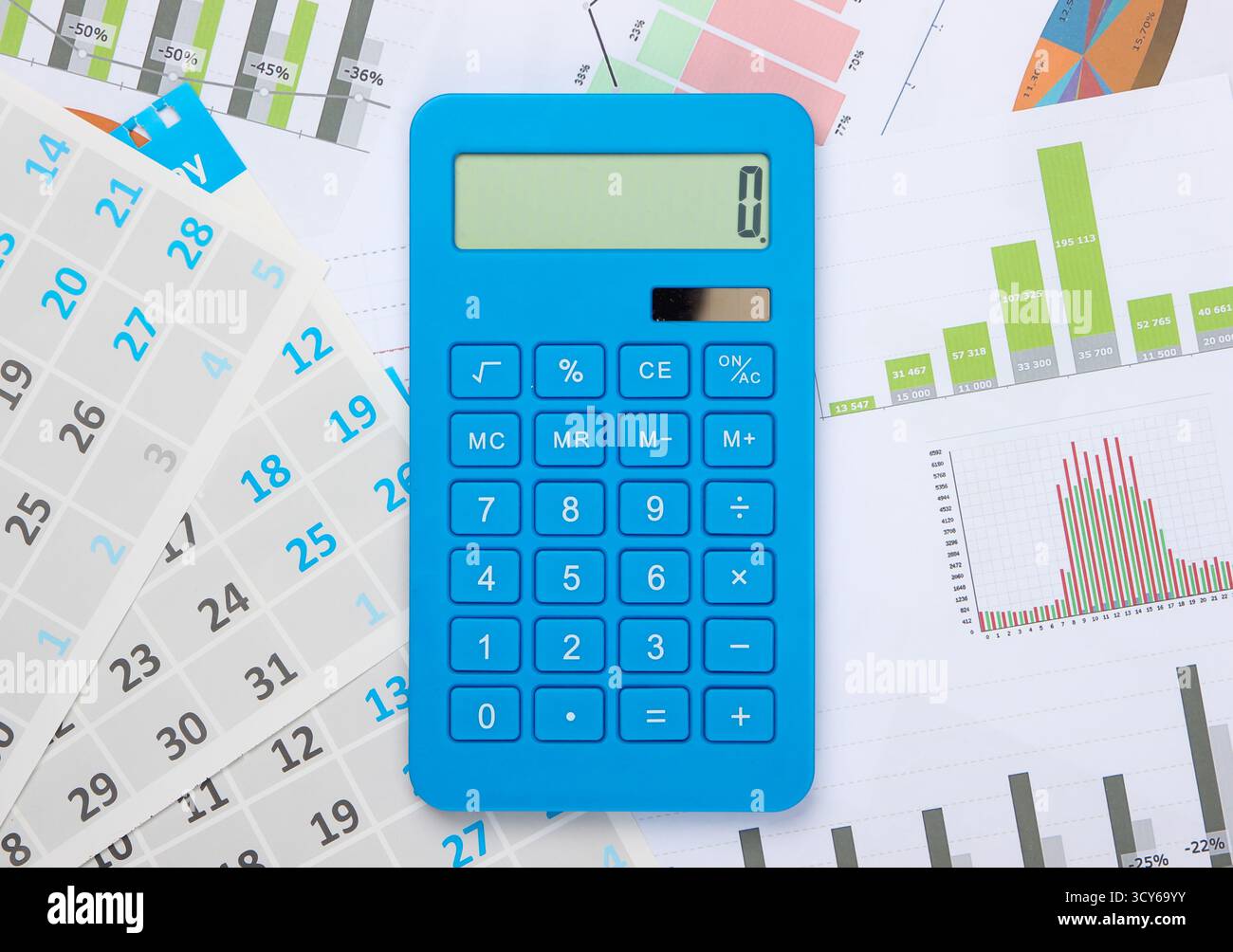 Calculator with graphs and charts, monthly calendar close up. Economic ...