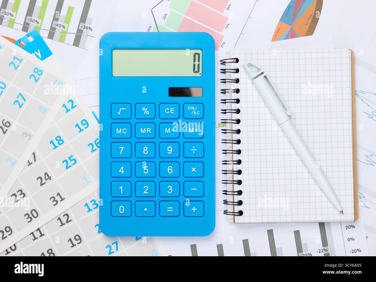 Calculator with notebook, graphs and charts, monthly calendar. Economic ...